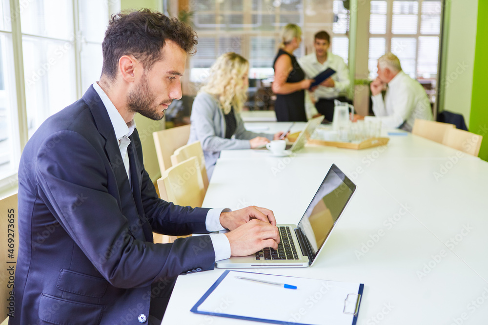 Businessman doing research on laptop computer Stock Photo | Adobe Stock