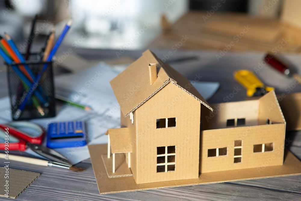 Workplace of architect - construction drawings, scale model and tools ...