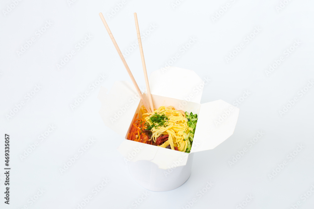 Rice wok in box and wooden chopsticks isolated on white background ...