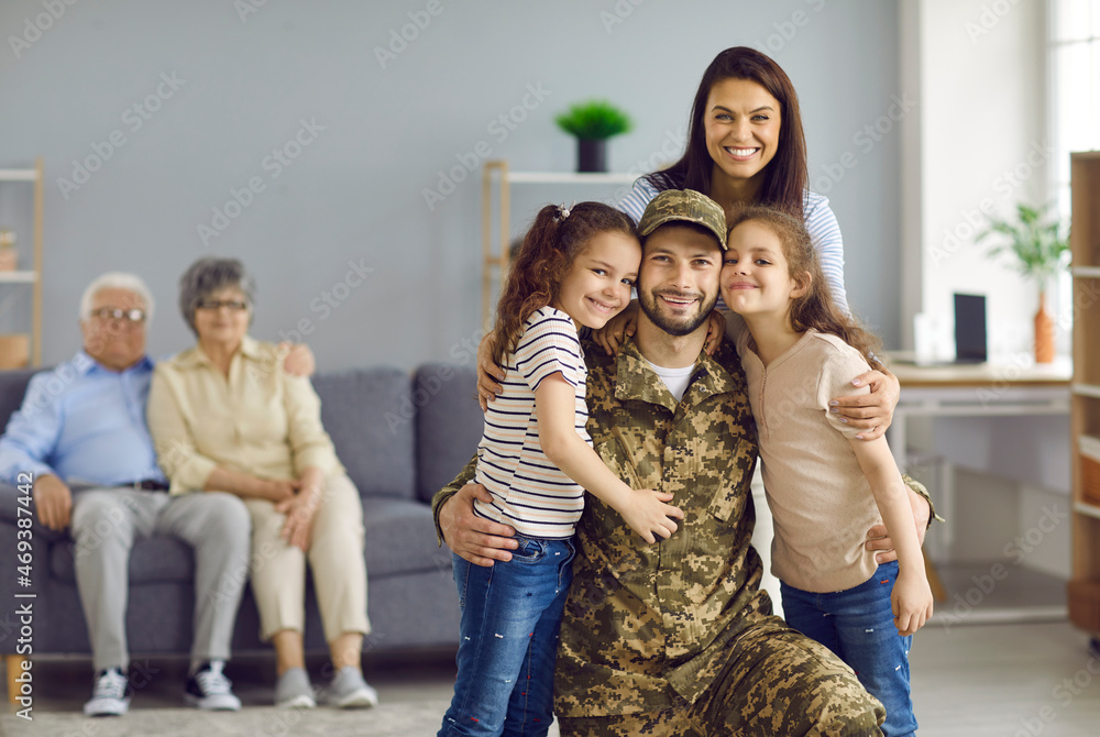 Veteran soldier comes back to his family from the military. Happy wife ...