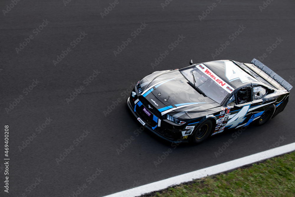 High angle view of racing car Ford Mustang speed on asphalt racetrack ...