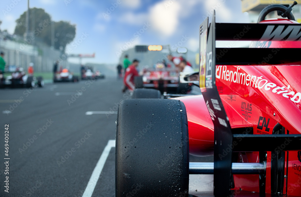 Rear view of formula cars on asphalt racetrack starting race grid Stock ...