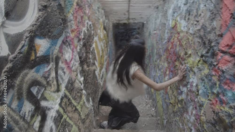 An interpretive dancer in slow motion flips her long dark hair around ...