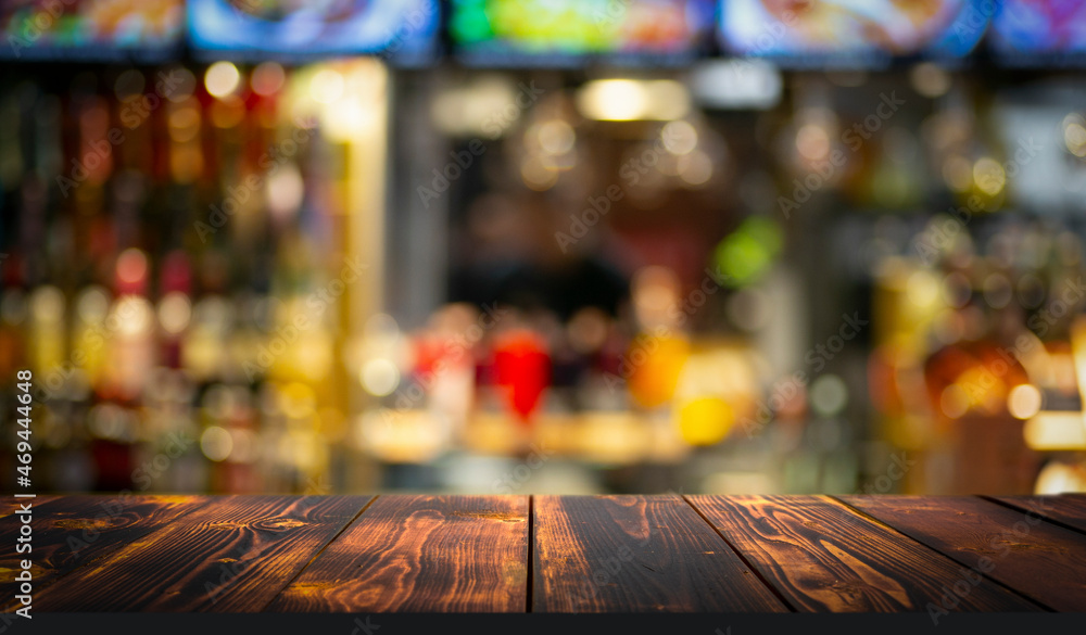 Wooden table rustic bar background. Bar and restaurant blurred ...