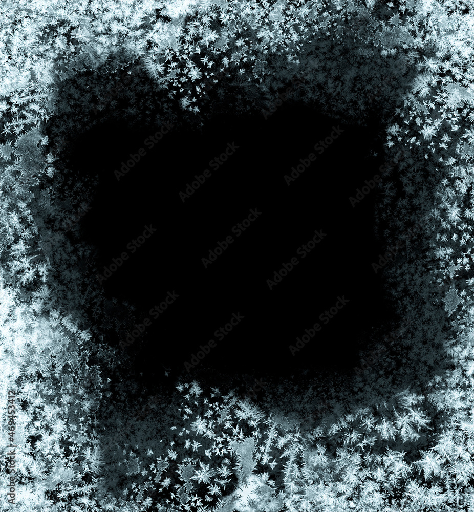 A frame of a frosty pattern of ice crystals on a black background. A ...