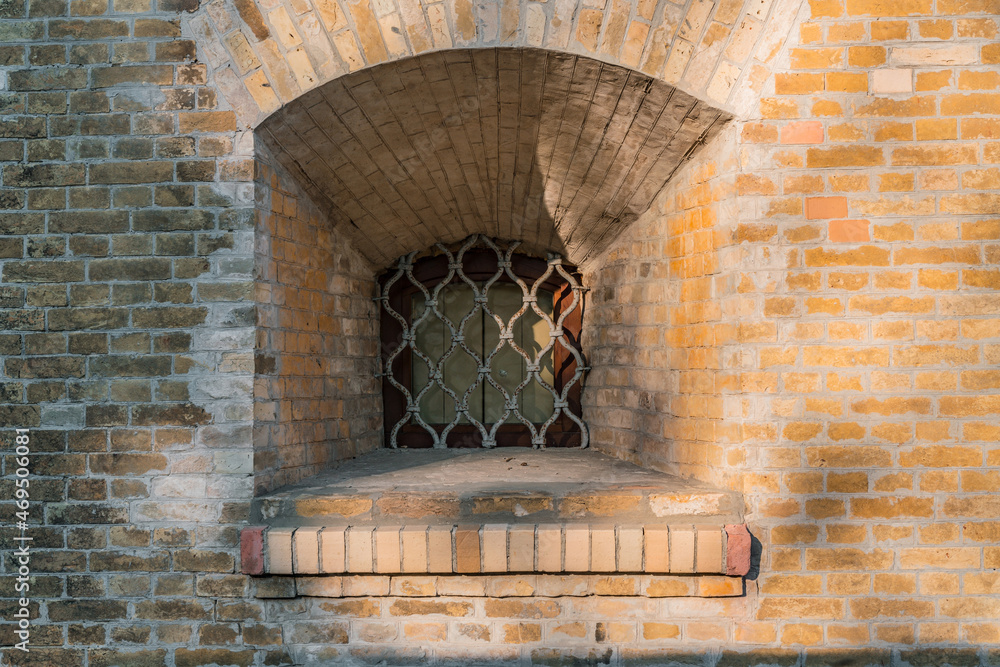 Wooden small arch window of medieval fortress with fat walls and ...