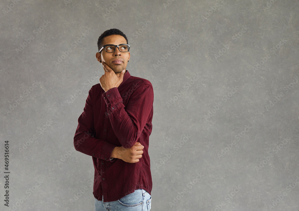 Studio portrait of pensive thoughtful young african american man in ...