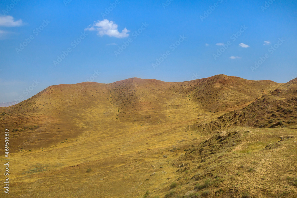 Hilly valley, scorched by the sun, at the foot of the Gissar range ...