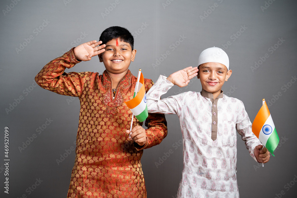 HIndu Muslim Children saluting by holding Indian flag on gray ...