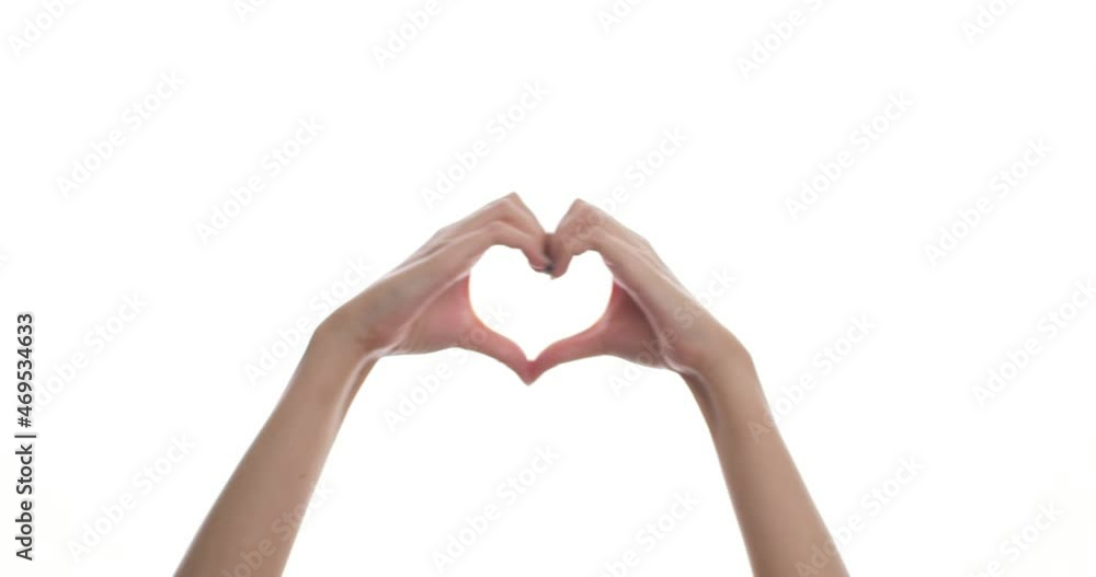Close-up of a woman's hand shows a heart sign, like, good, class ...