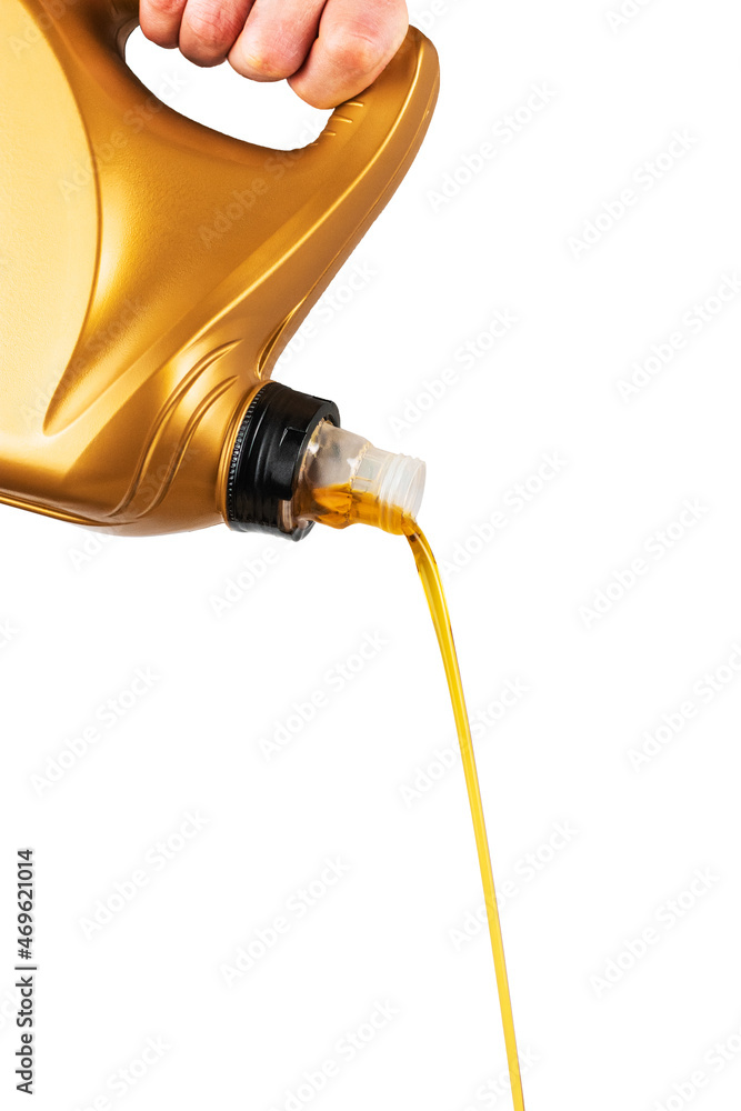 Engine oil pouring from a canister in hand isolated on white background ...