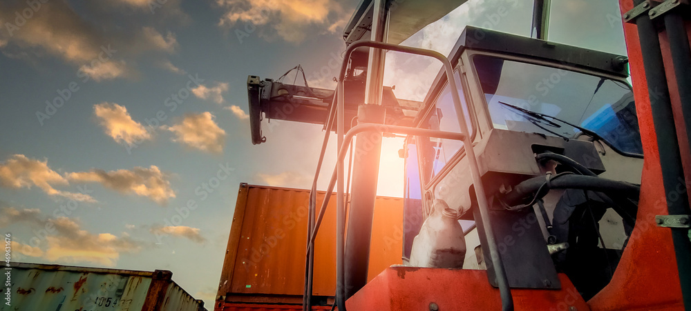 Reach stacker lifting container. Forklift truck handling container at ...