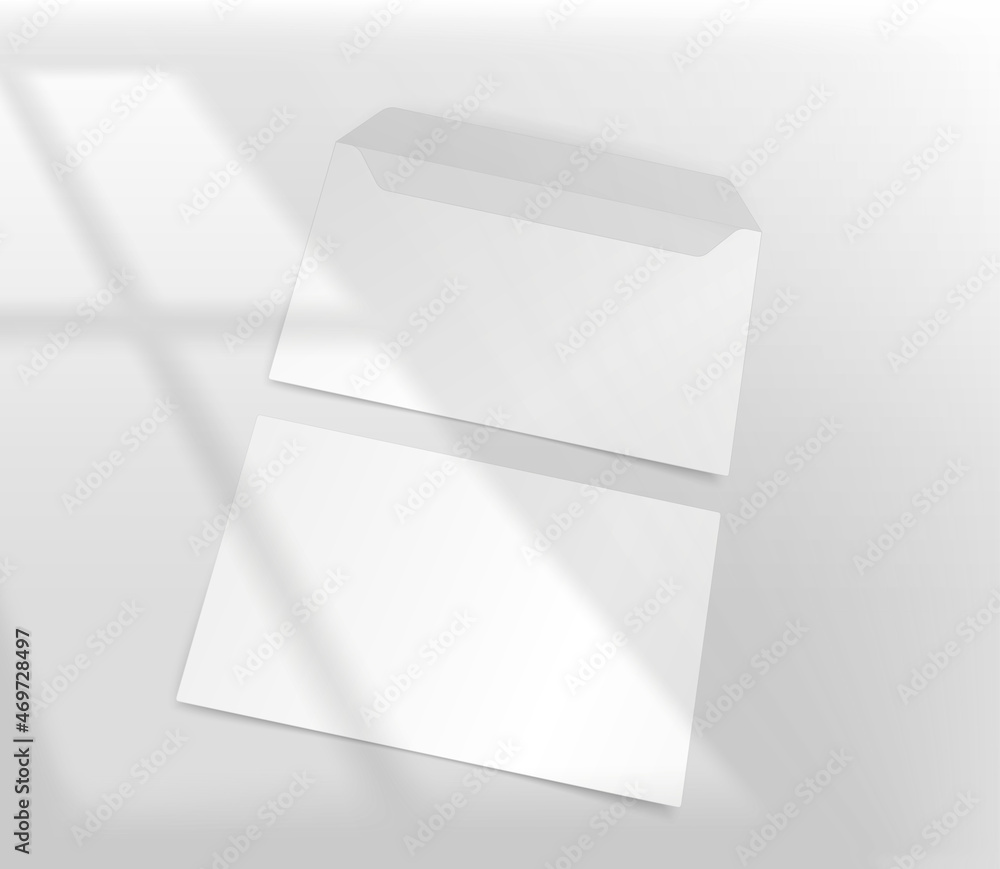 White paper envelope on a table with light of the window shadow overlay ...