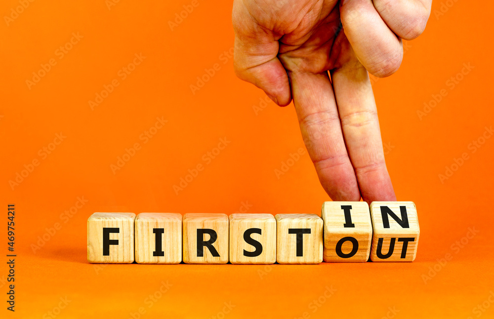 First in first out symbol. Businessman turns wooden cubes and changes ...