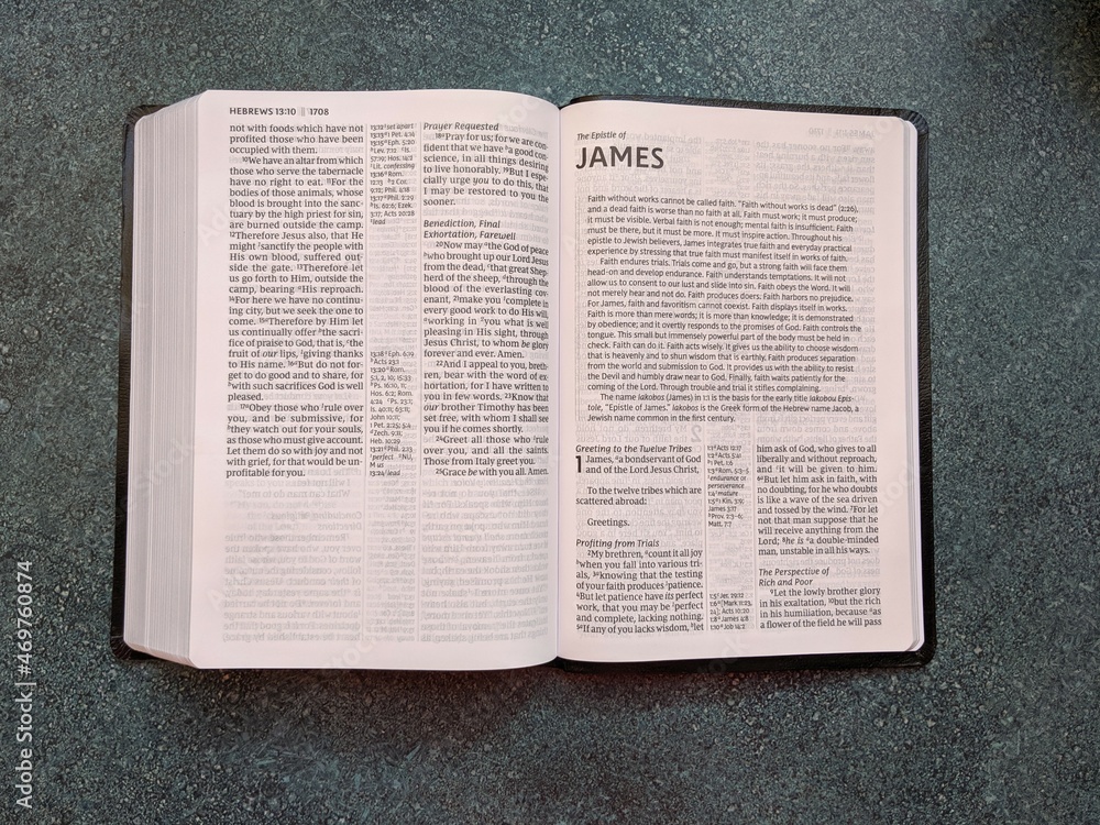 The bible open up to the book of James, laying flat on a table Stock ...