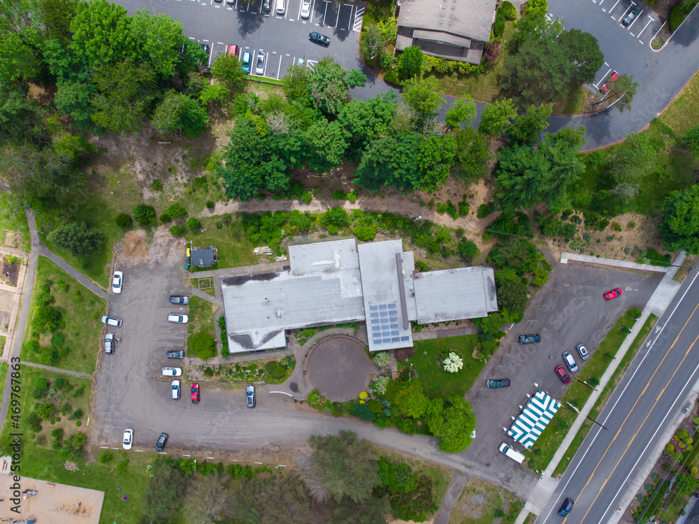 A shot from the air. Small suburb. Lots of greenery. Paved roads and ...