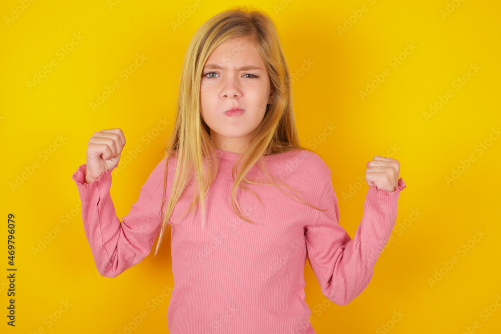 Irritated caucasian little kid girl wearing long sleeve shirt over ...