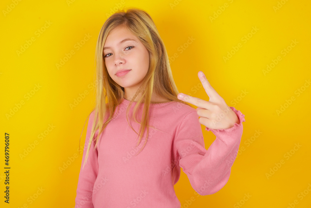 caucasian little kid girl wearing long sleeve shirt over yellow ...