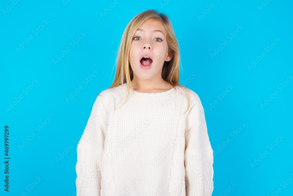 Emotional attractive caucasian little kid girl wearing wool jersey over ...