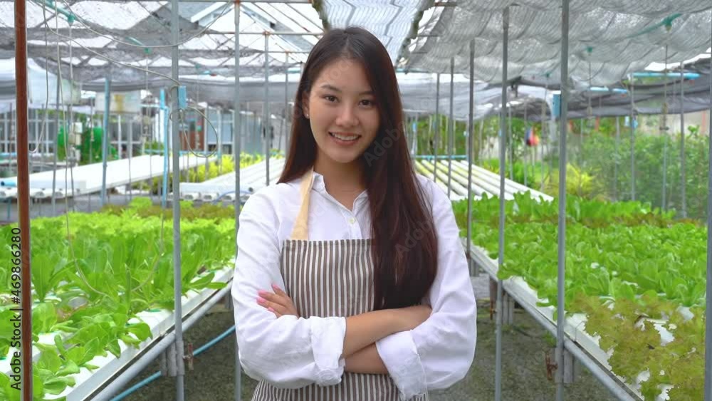 New generation of smiling young asian girl farmer standing with his ...