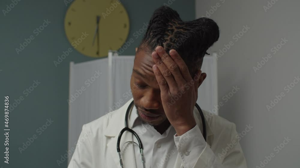 Portrait of male doctor or intern looking at camera, expressing ...