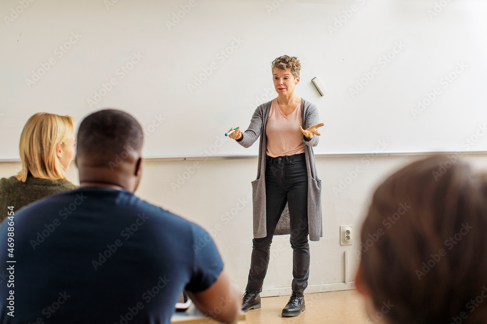 Teacher giving lecture in classroom Stock Photo | Adobe Stock