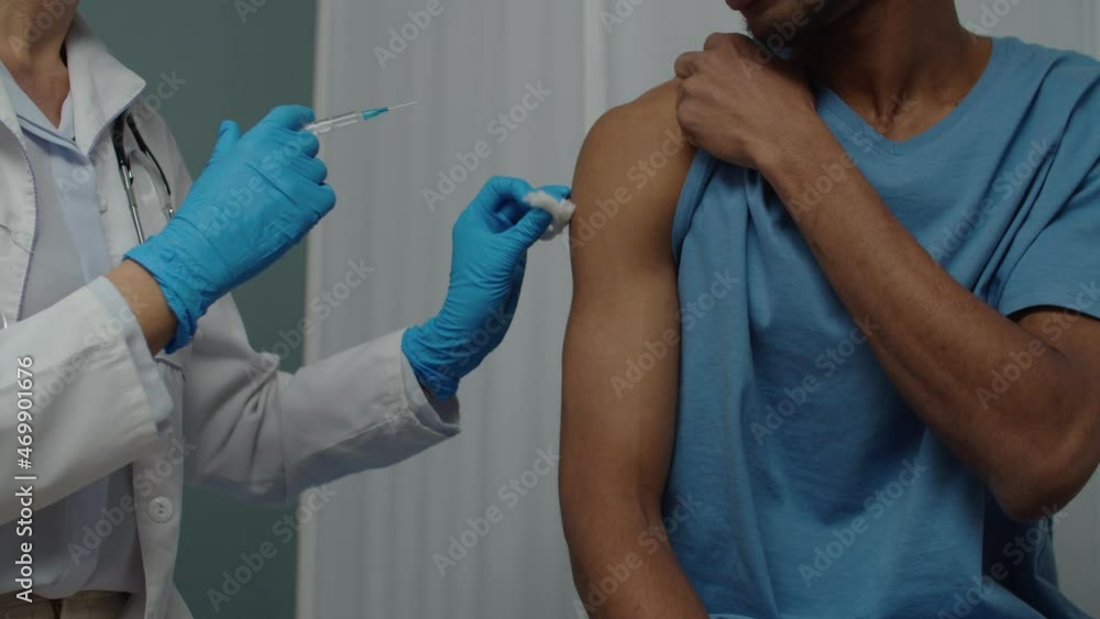 Unrecognizable female doctor or medical nurse in safety gloves making ...