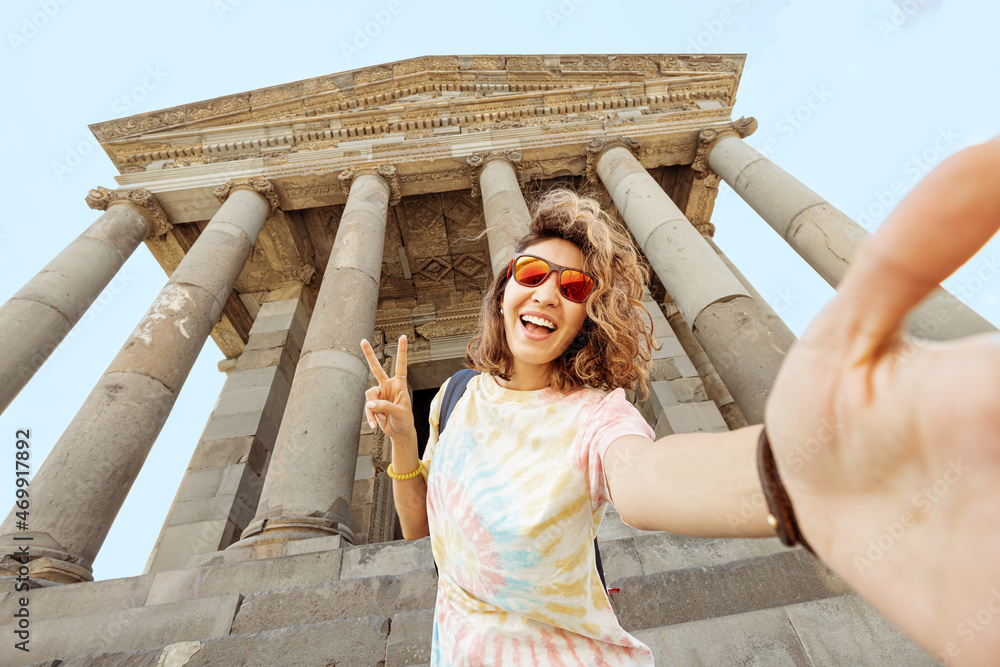 Happy female tourist takes a selfie photo against the background of the ...