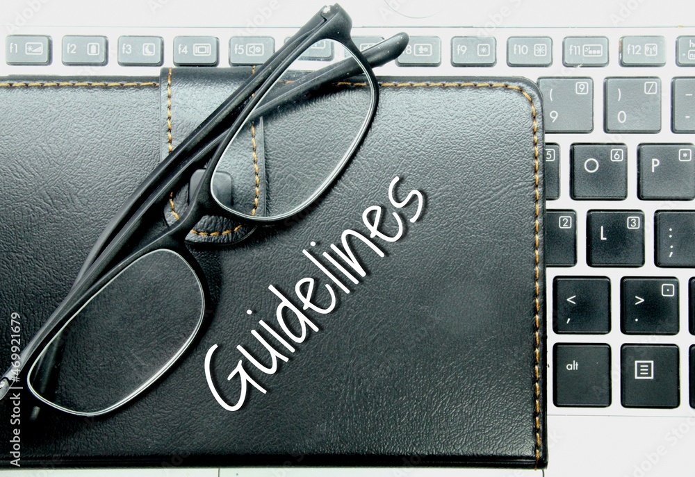 laptop keyboards, glasses and notebooks with the word guidelines Stock ...
