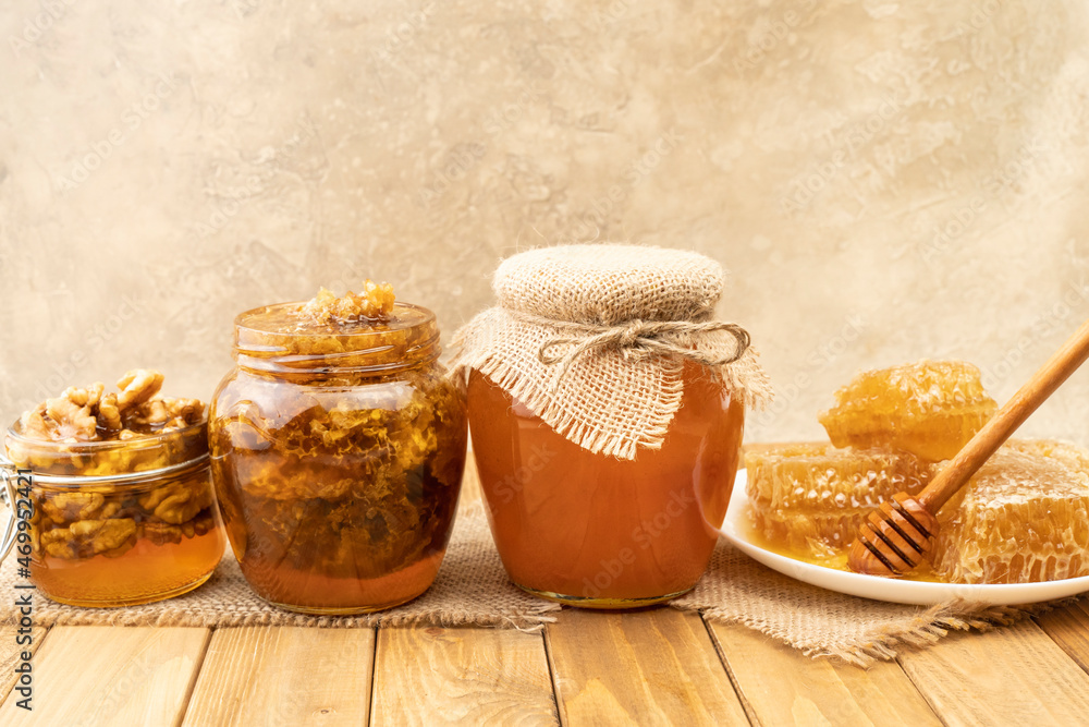Assortment of honey products: honeycombs, nuts in honey, beeswax in ...