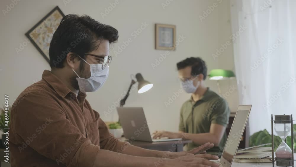 Two Indian male or men office corporate employees taking precautionary ...