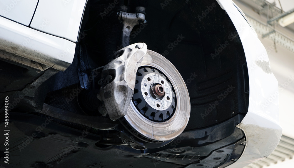 The brake disc and brake caliper are installed on a modern powerful car ...