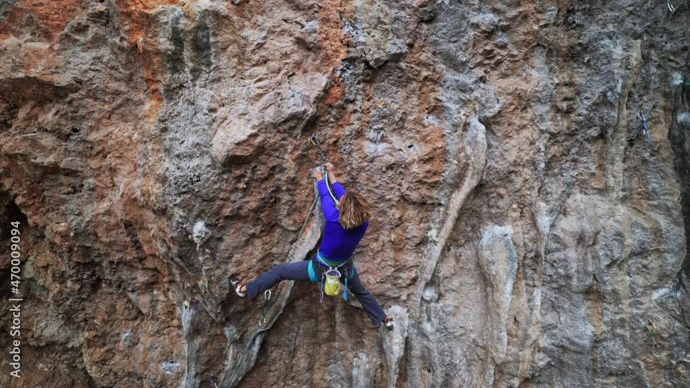 cinematic slow motion footage of strong female climber climbing very ...