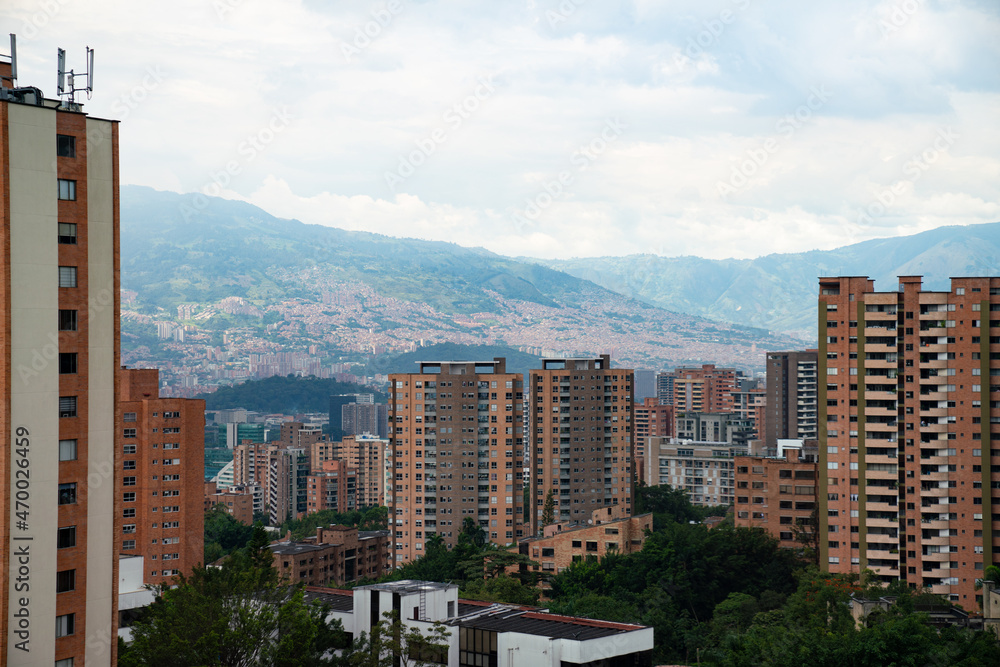 skyline of medellin colombia filled with many buildings and mountains ...