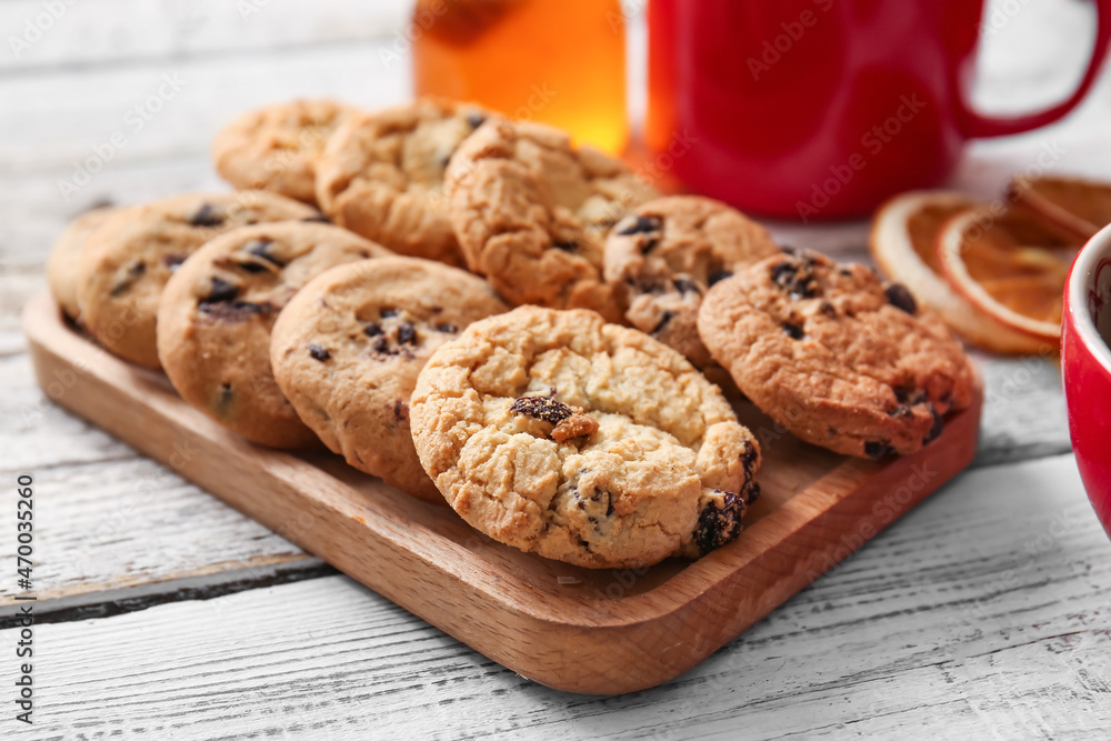Board of tasty homemade cookies with chocolate chips on white wooden ...