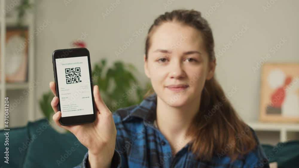Woman showing on phone vaccination passport with qr code, international ...