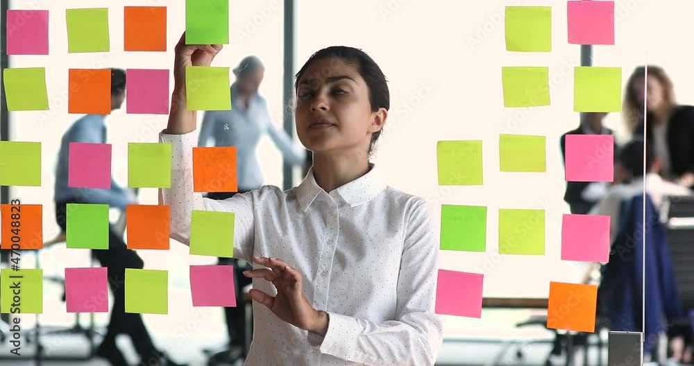 Young Indian woman write down step by step instructions for different ...