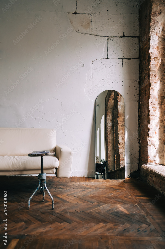Old fashioned interior big wooden window and mirror, white sofa in old ...