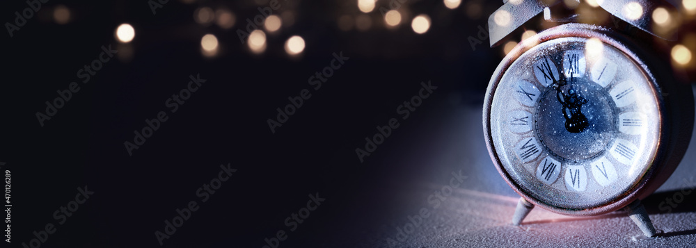 Midnight countdown with a alarm clock on black background with golden ...