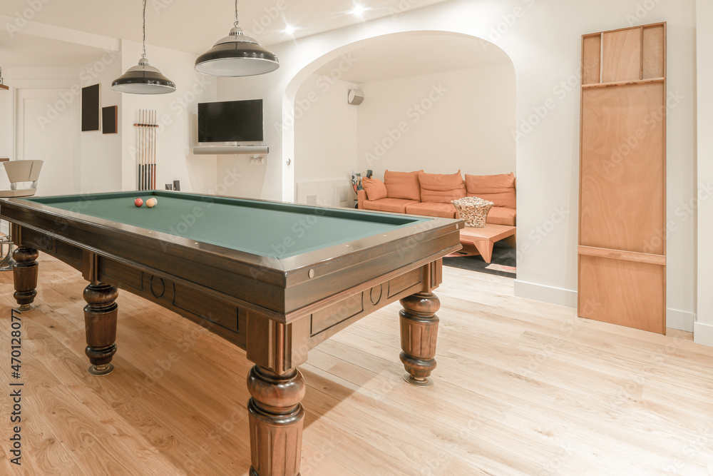 Billiard room with pool table and rest zone Stock Photo | Adobe Stock