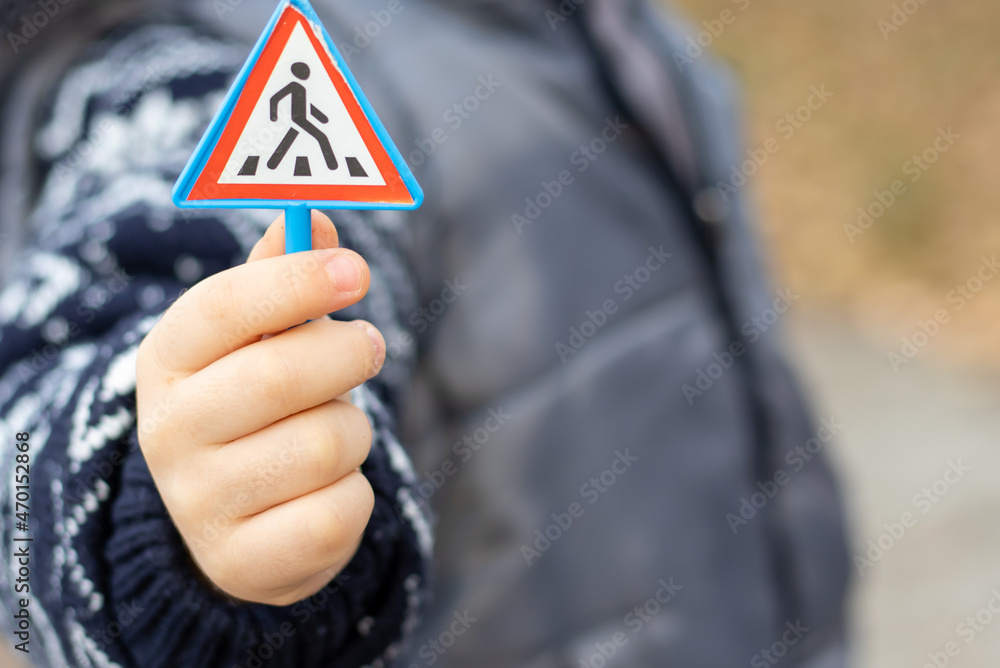 toy traffic signs in a kid boy hand. plastic road sign with speed limit ...