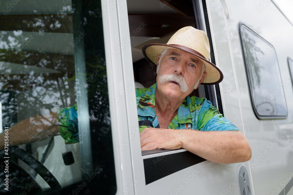 elderly man driving camper van Stock Photo | Adobe Stock