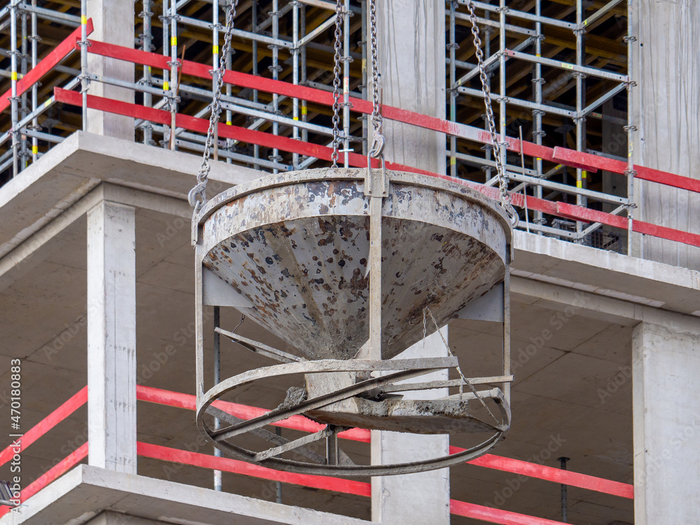 Crane lifting concrete container on construction site. Construction of ...