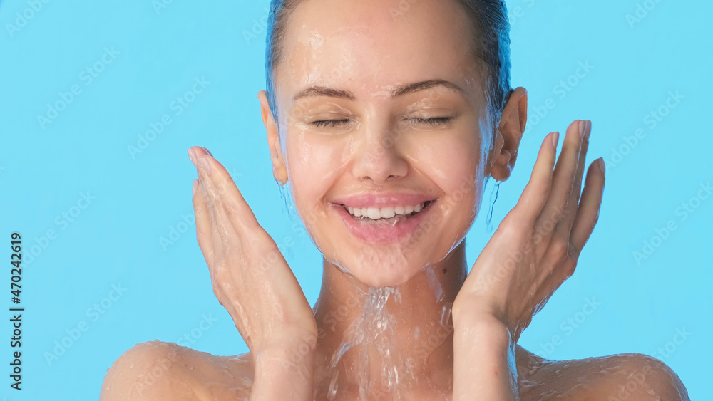 Woman washing her clean face with water. Closeup face of an Young girl ...