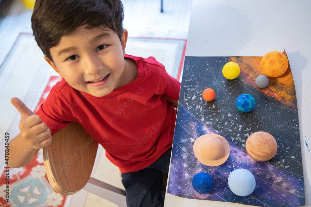 Happy preschooler made a solar system model. Handmade models of planets ...