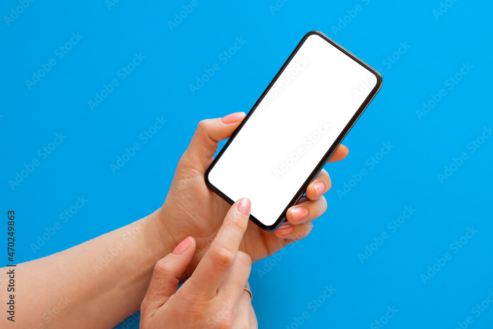 Person using mobile phone with blank screen on blue background Stock ...