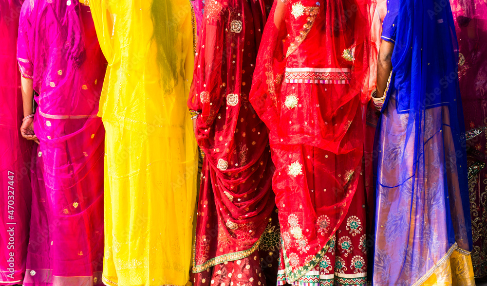 Indian women dressed in traditional colorful sari Stock Photo | Adobe Stock