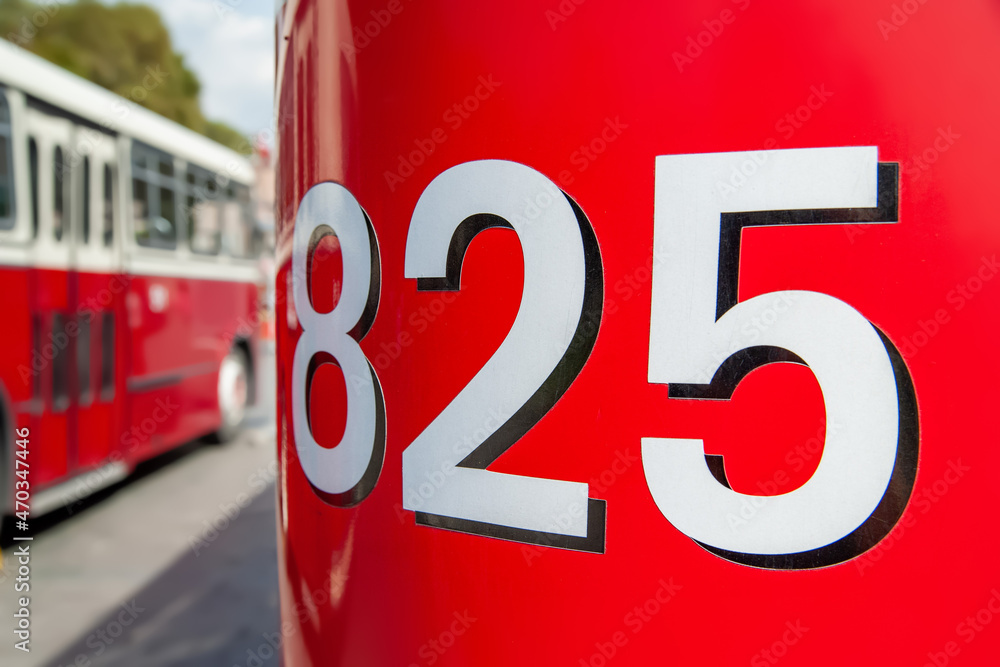 Bus number. Number 825 aboard a red old passenger bus. Retro transport ...