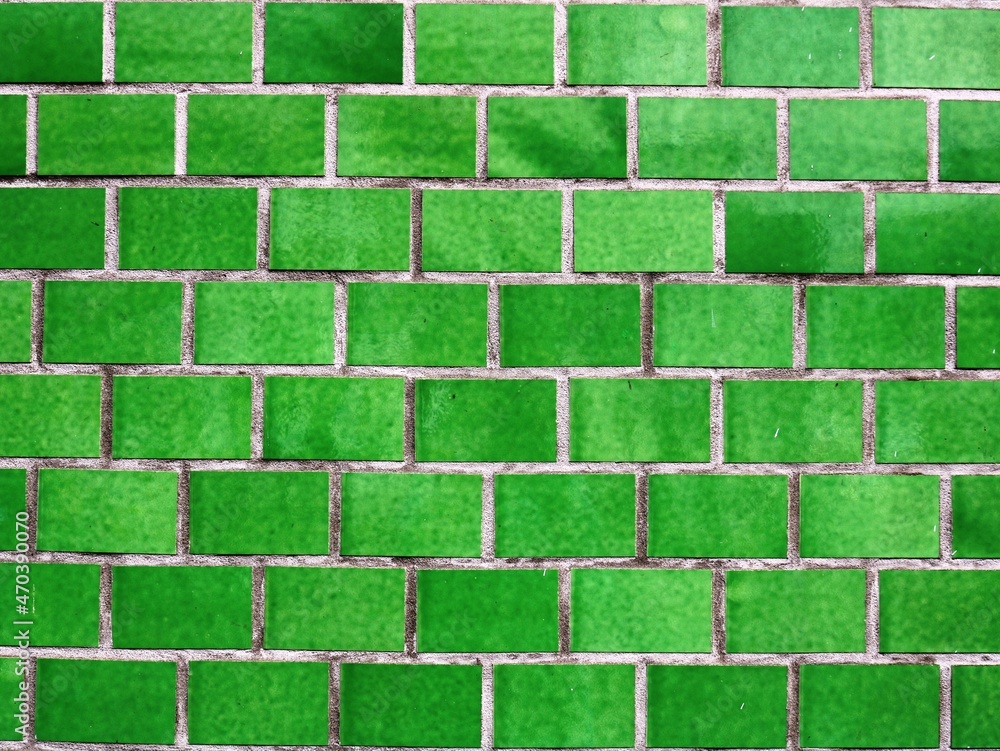 a graphic background of green blocks with gray lines of seams, an ...