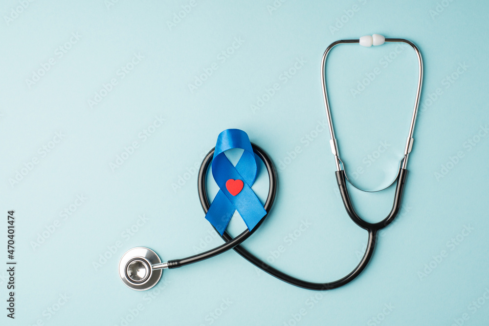 Top view photo of stethoscope and blue silk ribbon with small red heart ...